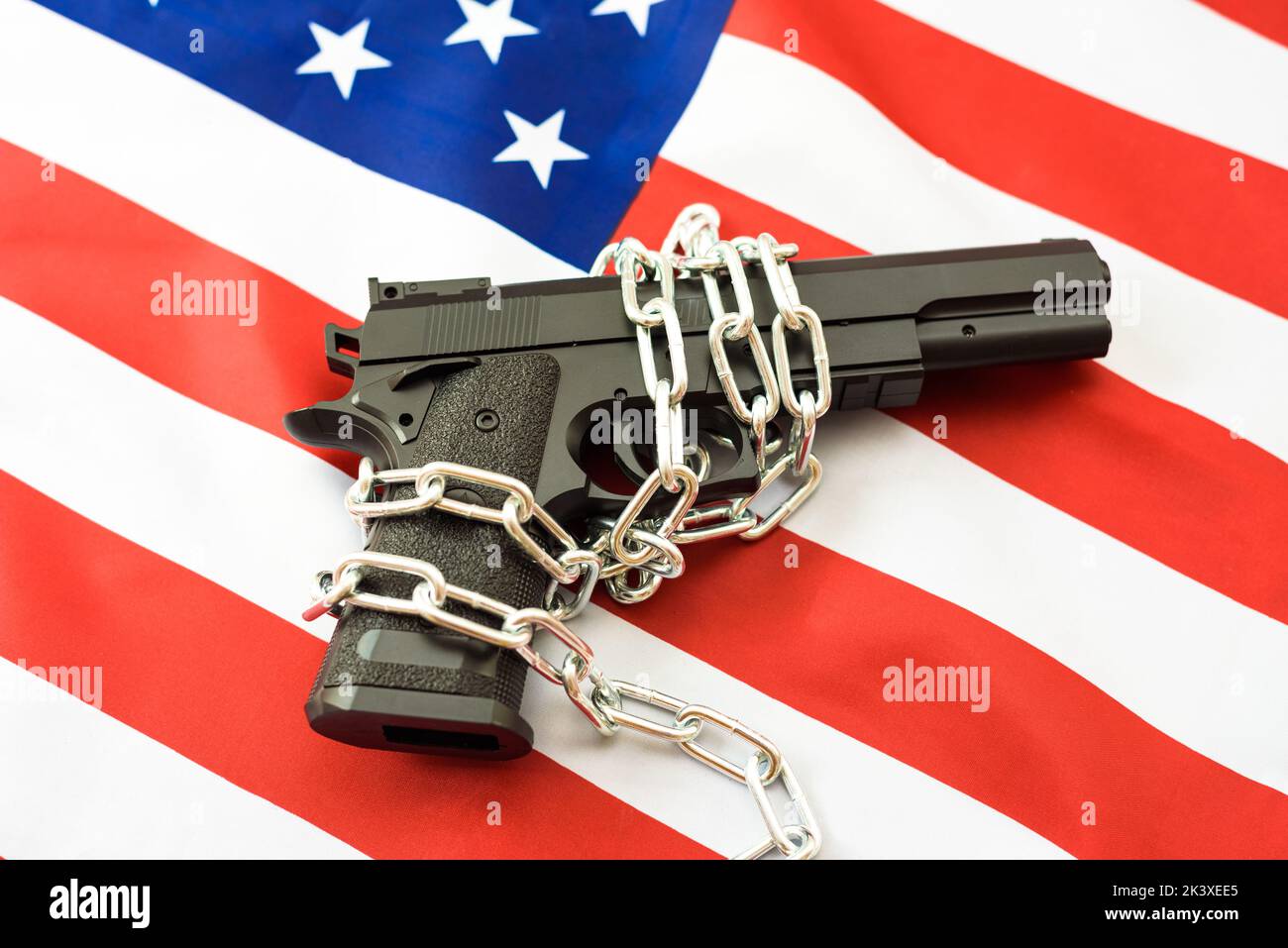 Gun over American patriotic flag, firearms restriction debate Stock ...
