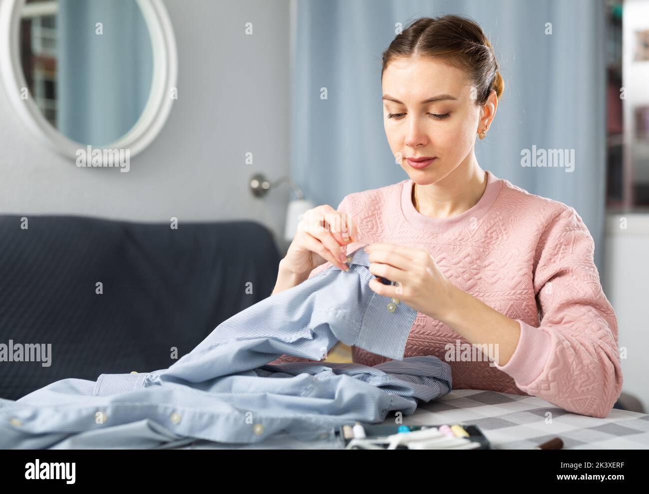 Female hands sewing button hi-res stock photography and images - Alamy