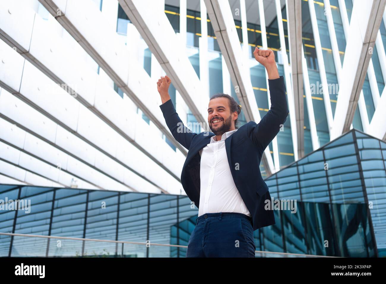 Excited businessman in suit celebrating victory arms raised up ...