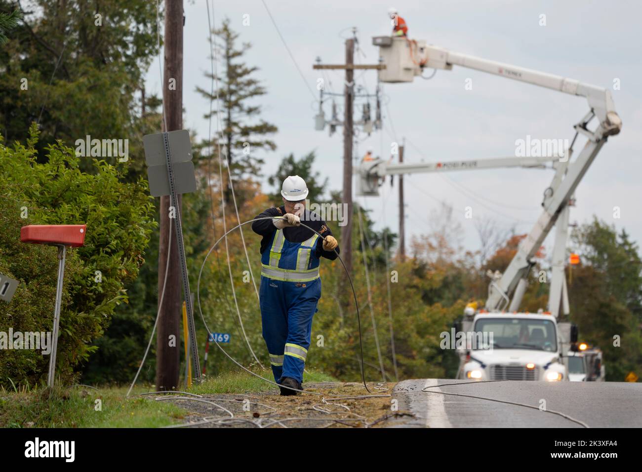 Power crews work to fix power lines near Lower Barneys River in Pictou County, N.S. on Wednesday ...