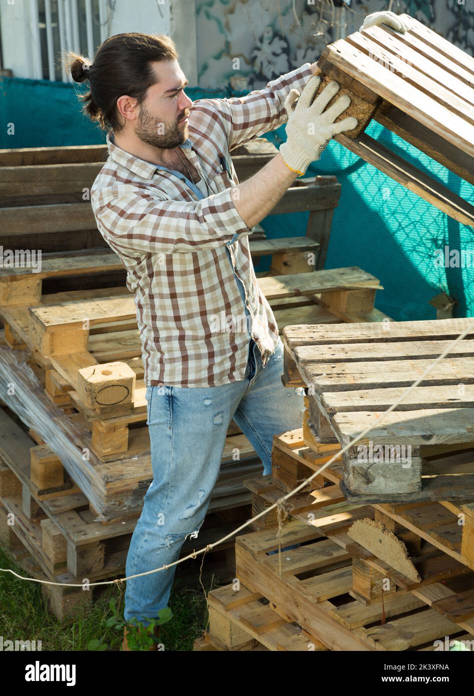 Man moving wooden pallets Stock Photo - Alamy