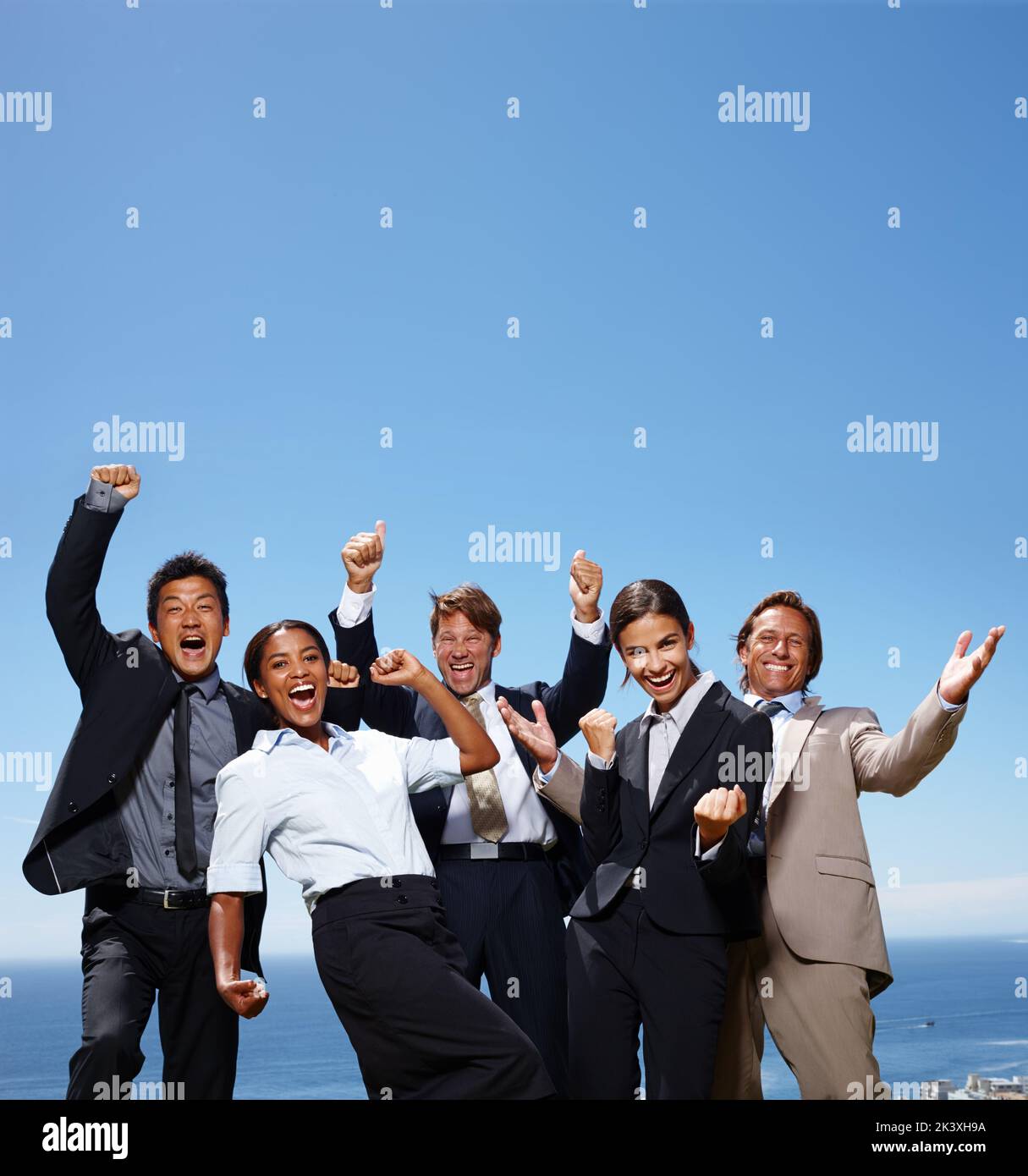 The skys the limit. a group of business people acting excited with ...