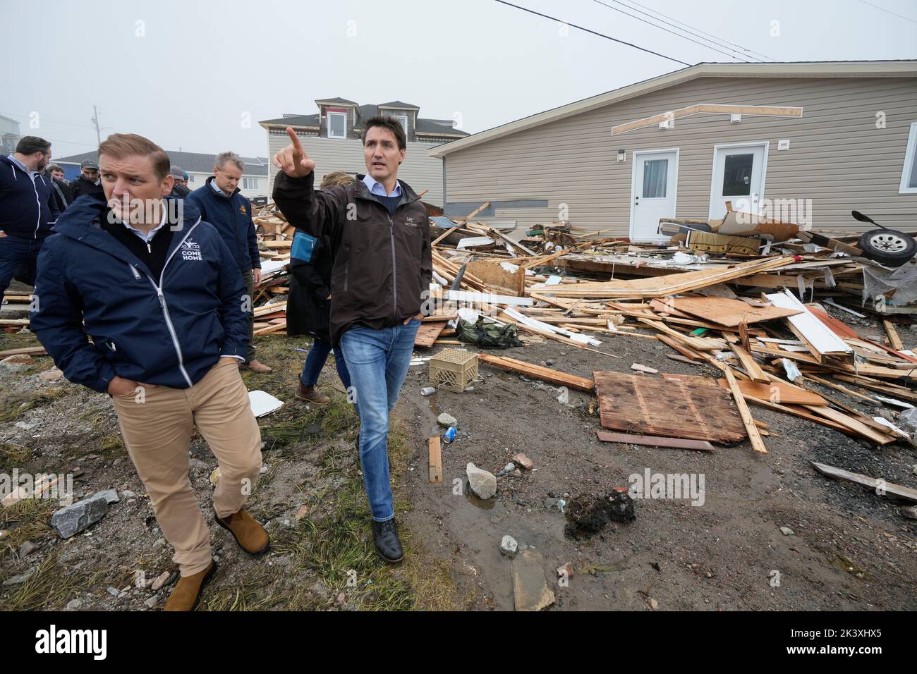 Prime Minister Justin Trudeau and Premier Andrew Furey, left, tour the damage caused by post ...