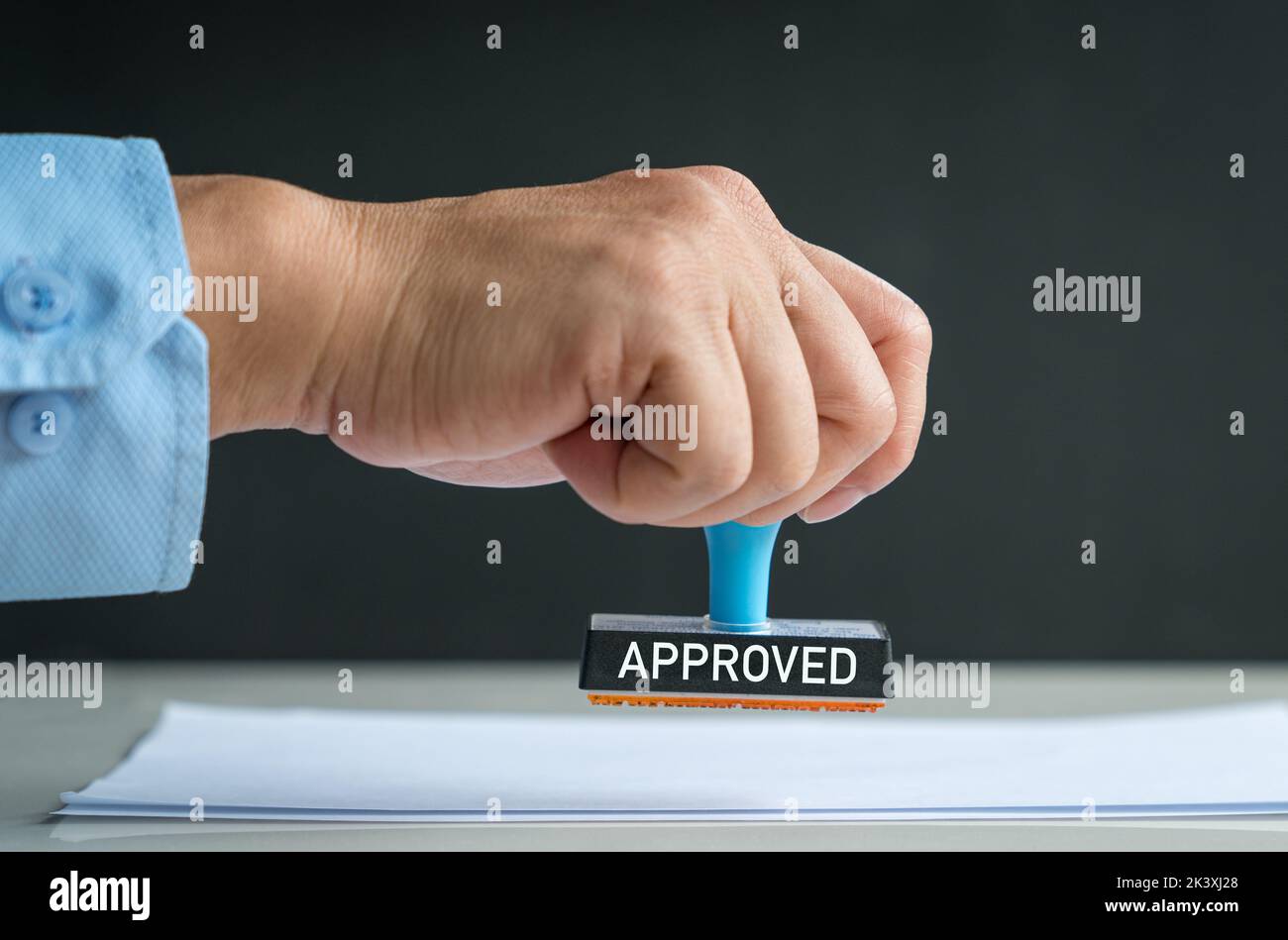 Approved notary rubber stamp. Man's hand pressing on document Stock ...