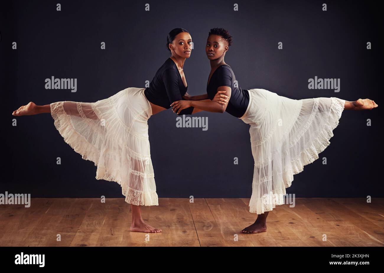 Balancing womahood. Two young female contemporary dancers using a soft ...