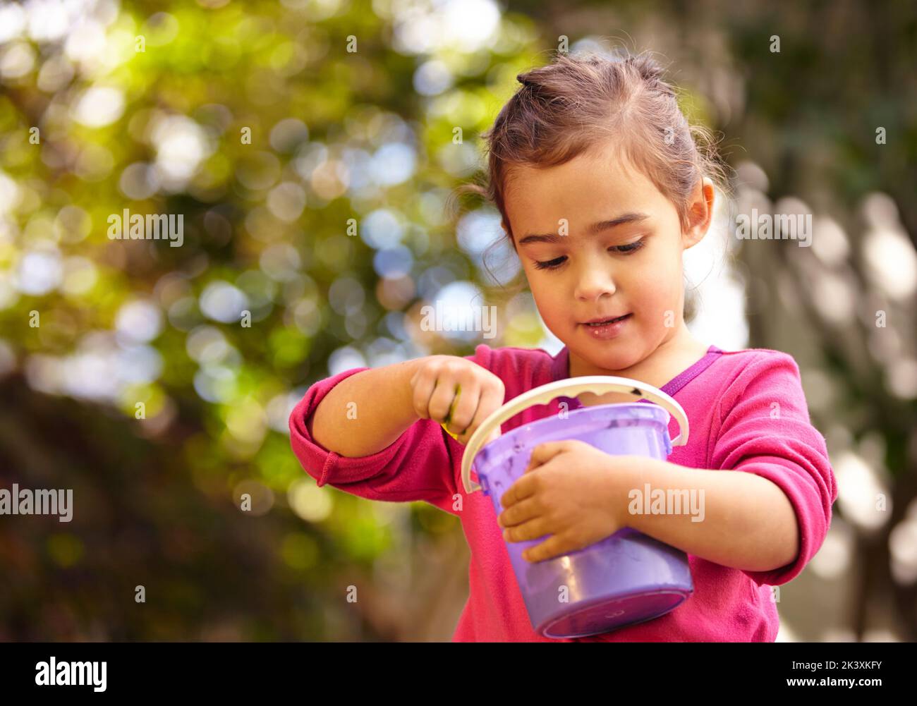 Children have the greatest imaginations. a little girl playing outside ...