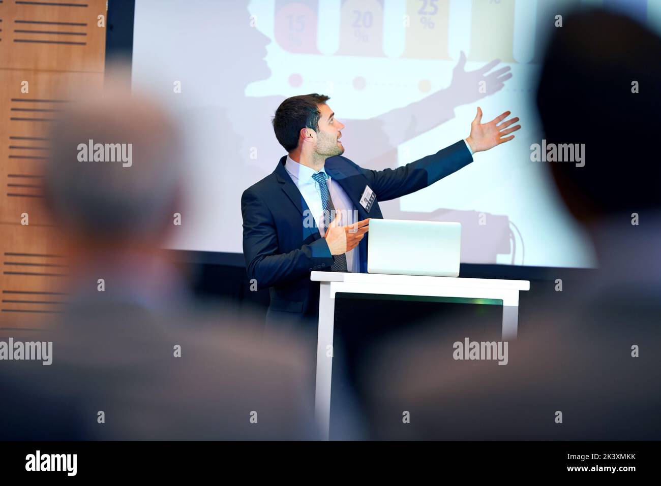 As you can see here...A businessman gesturing while giving a ...