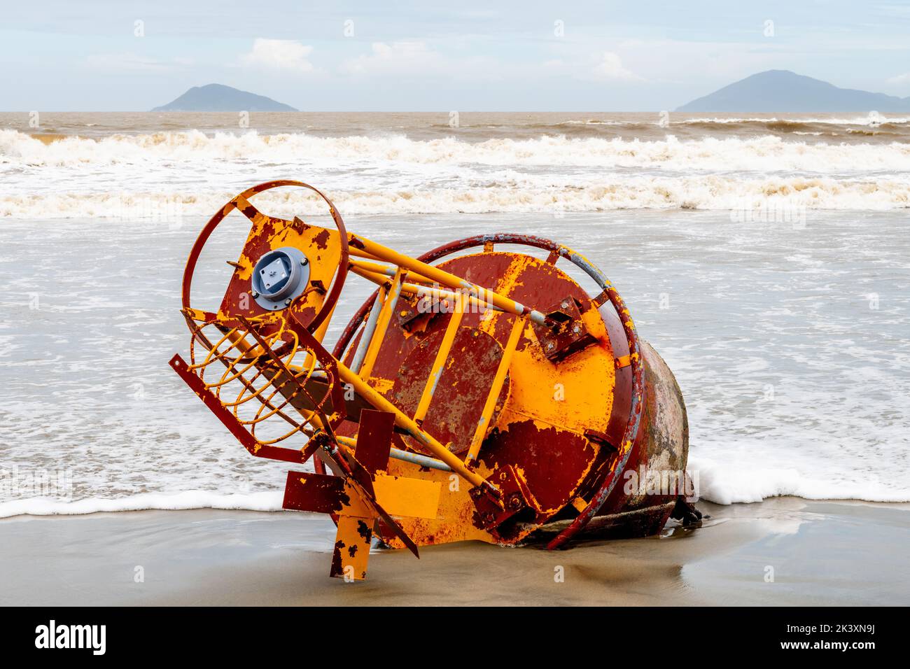 A large buoy buried in the sand at the beach after typhoon Noru went ...