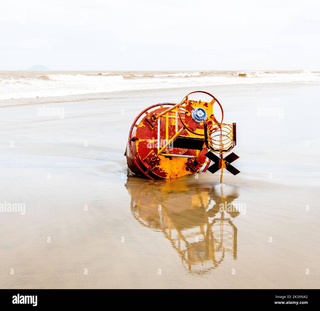 A large buoy buried in the sand at the beach after typhoon Noru went ...
