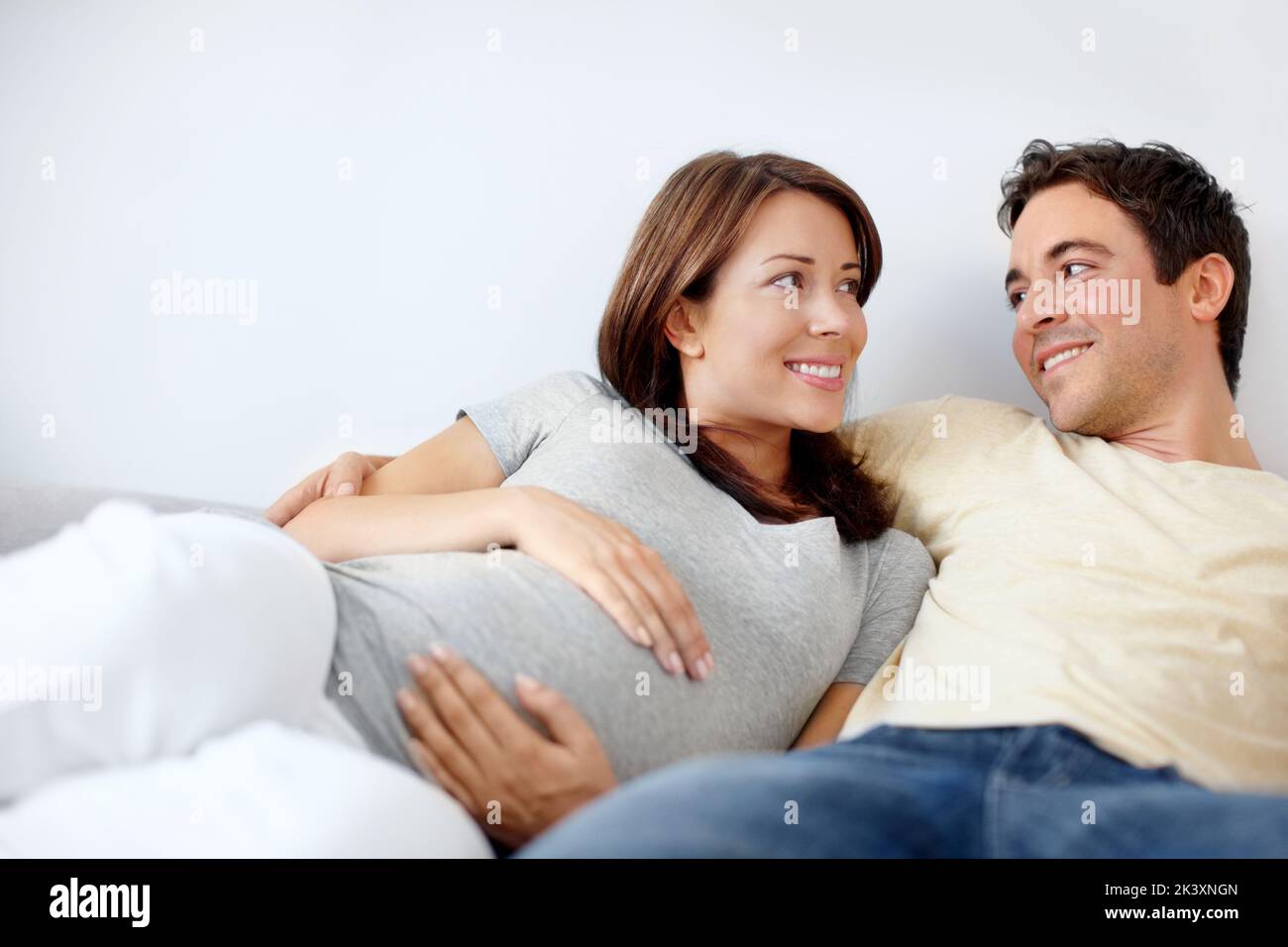 Taking this journey together. Happy expecting couple sitting in their ...