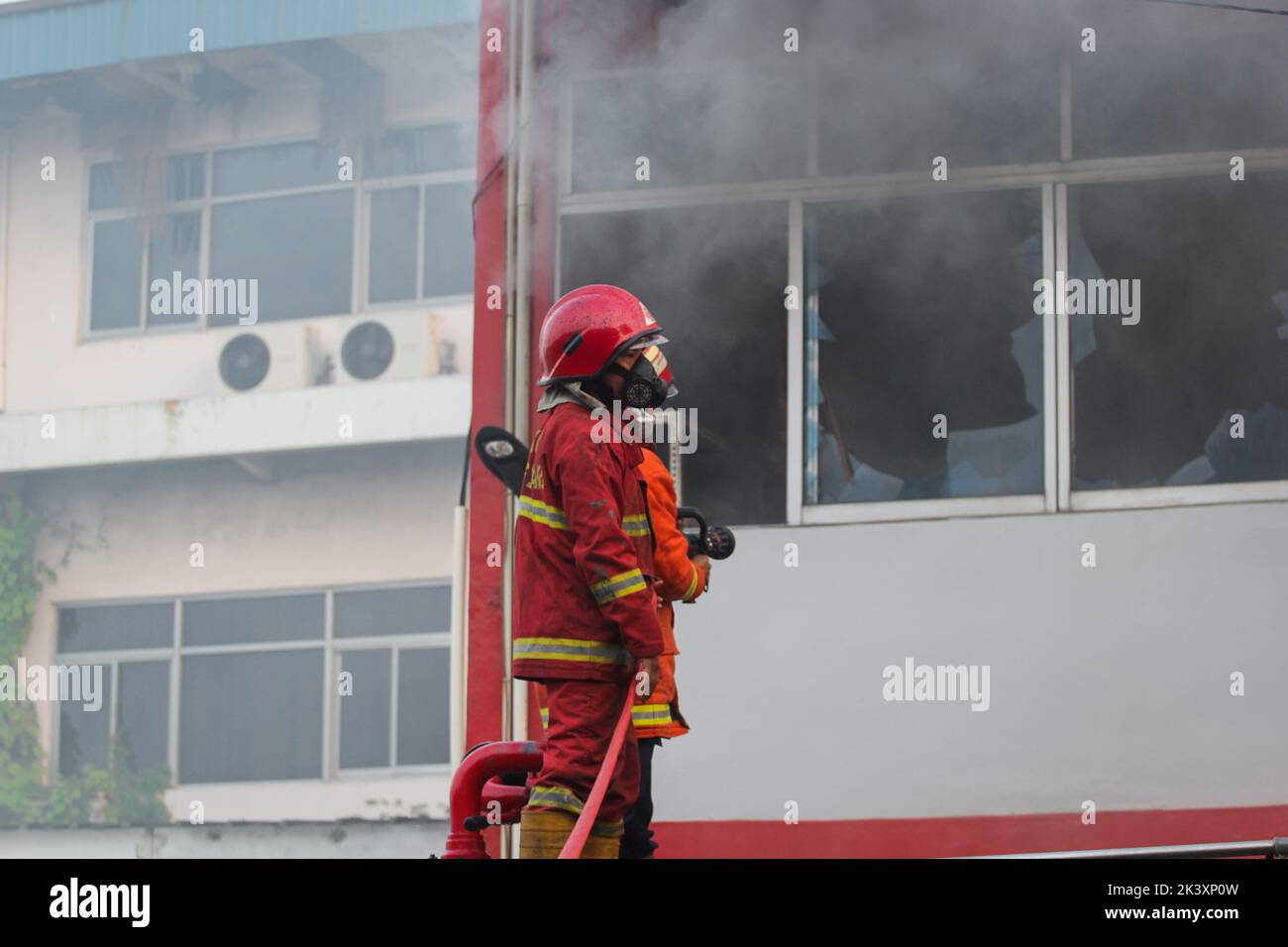 A closeup of a firefighter extinguishing the fire of the Padang ...