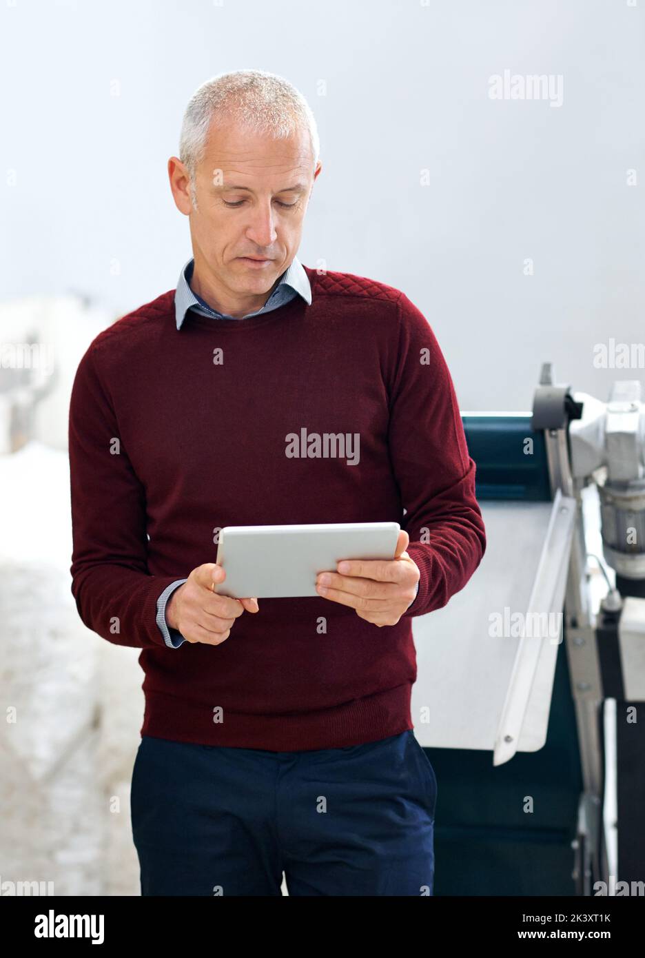 Recording productivity figures. a male factory manager using a digital ...