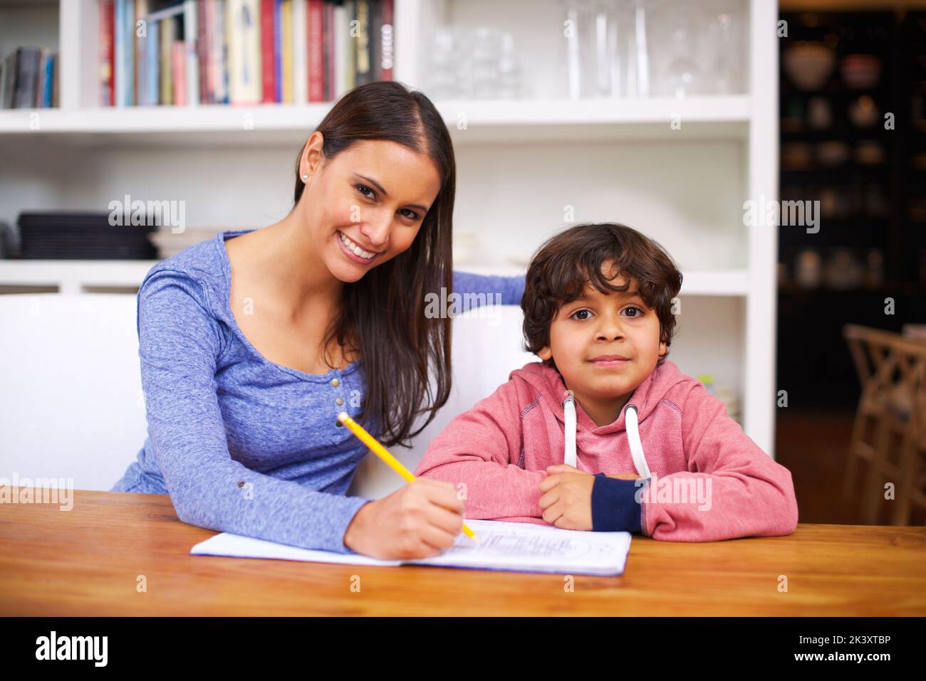 Helping with homework. a mother helping her son with his homework Stock ...