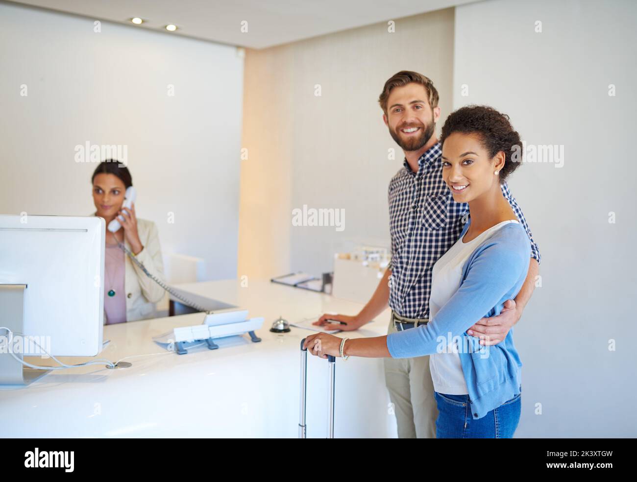 Were on honeymoon. a young couple checking in to a hotel Stock Photo ...