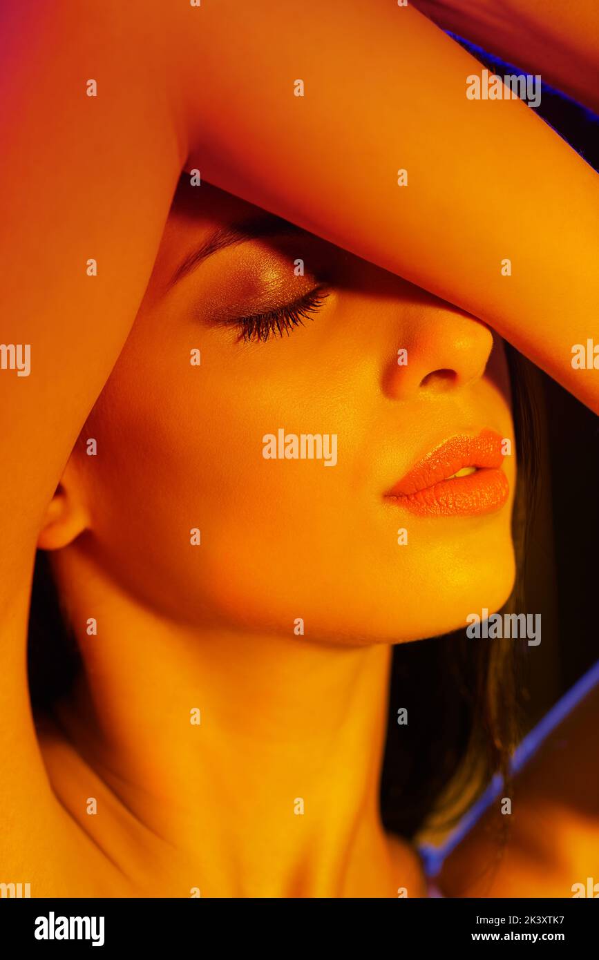 Shedding light on her beauty. A young woman with artistic lighting on ...