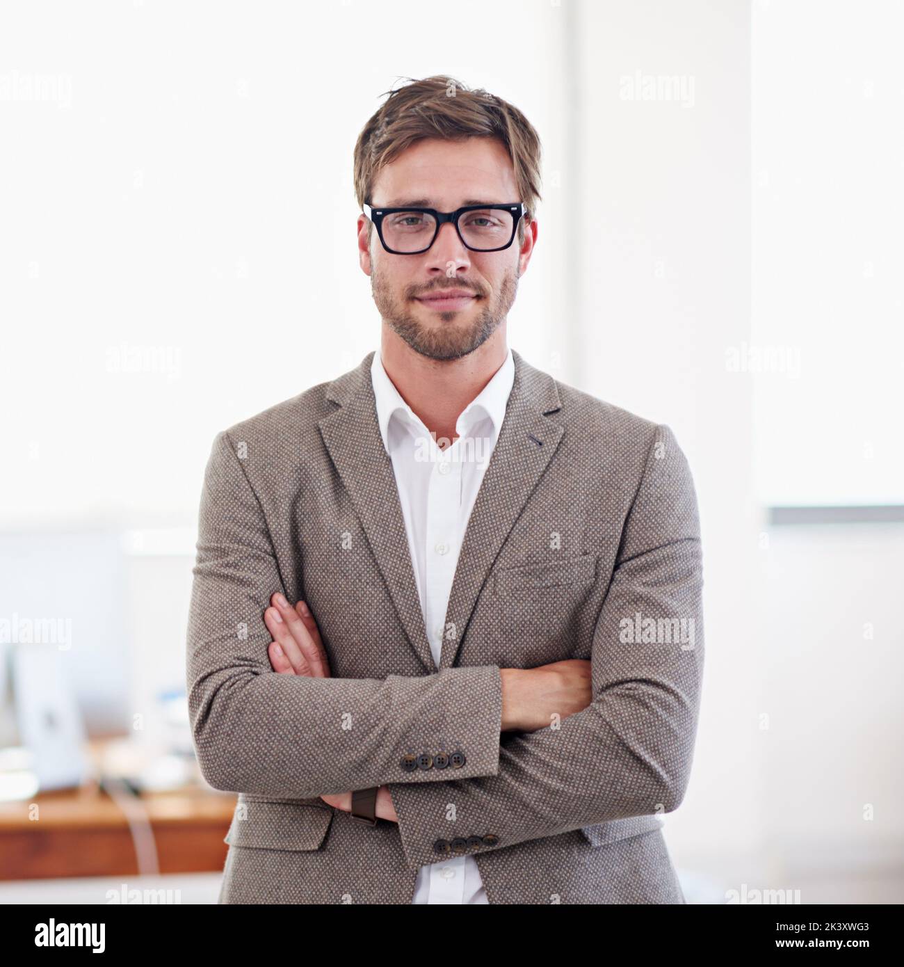 Ready to get down to work. a young man standing in an office Stock ...
