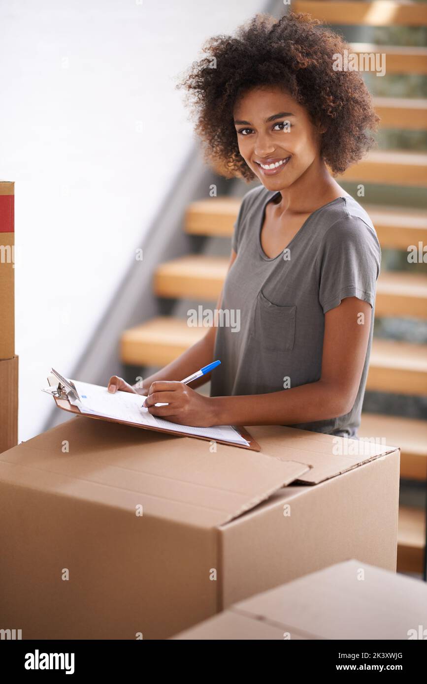 Heres to a new start. a young woman moving into her new house Stock ...