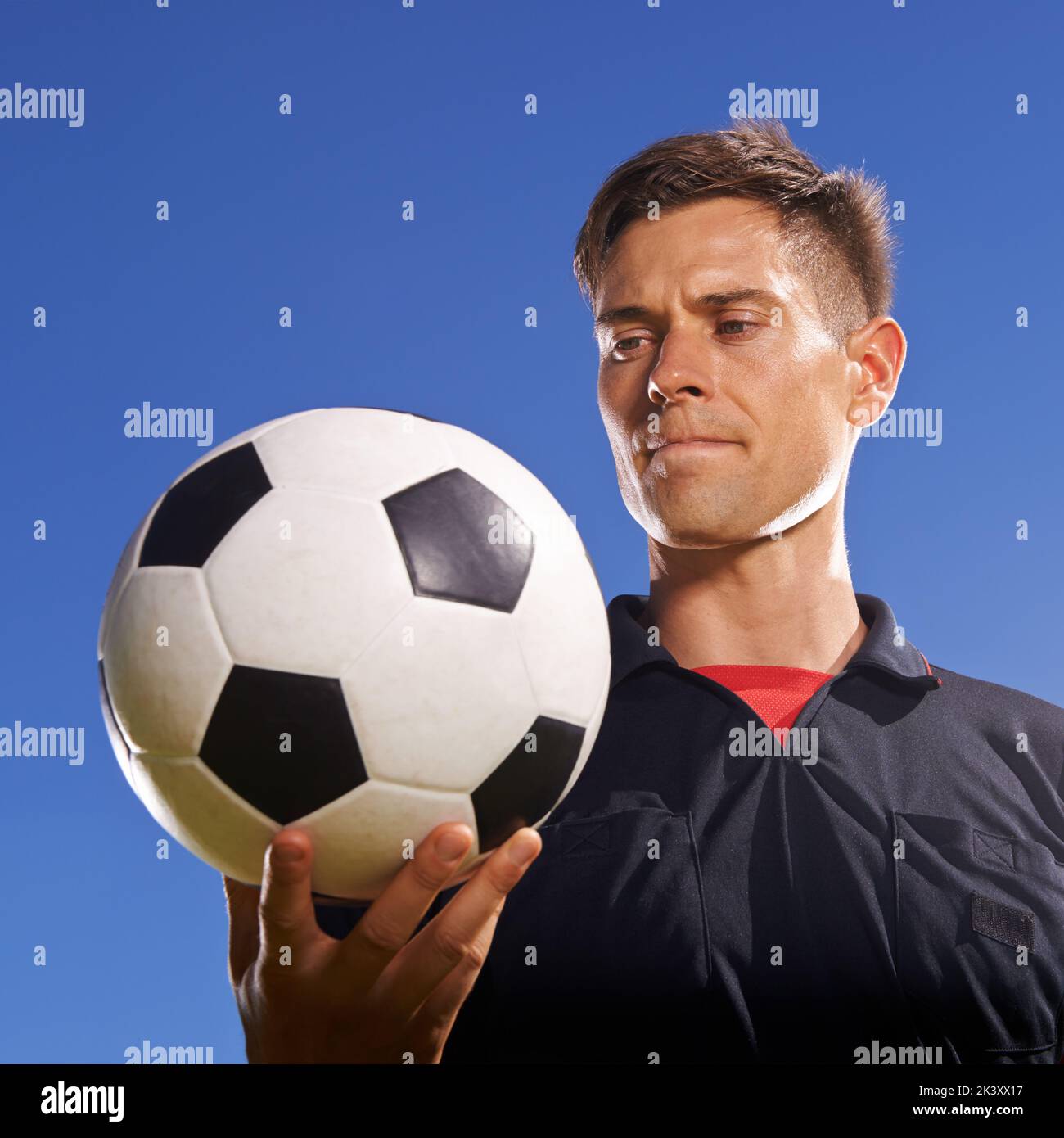 The match ball. a young footballer holding a ball in his hand Stock ...