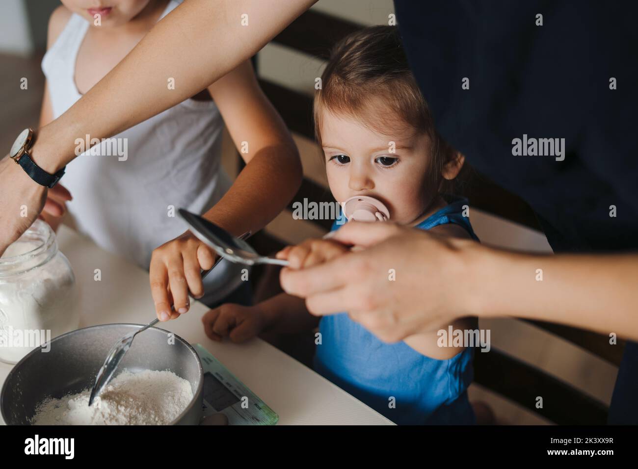 Child pouring flour hi-res stock photography and images - Alamy