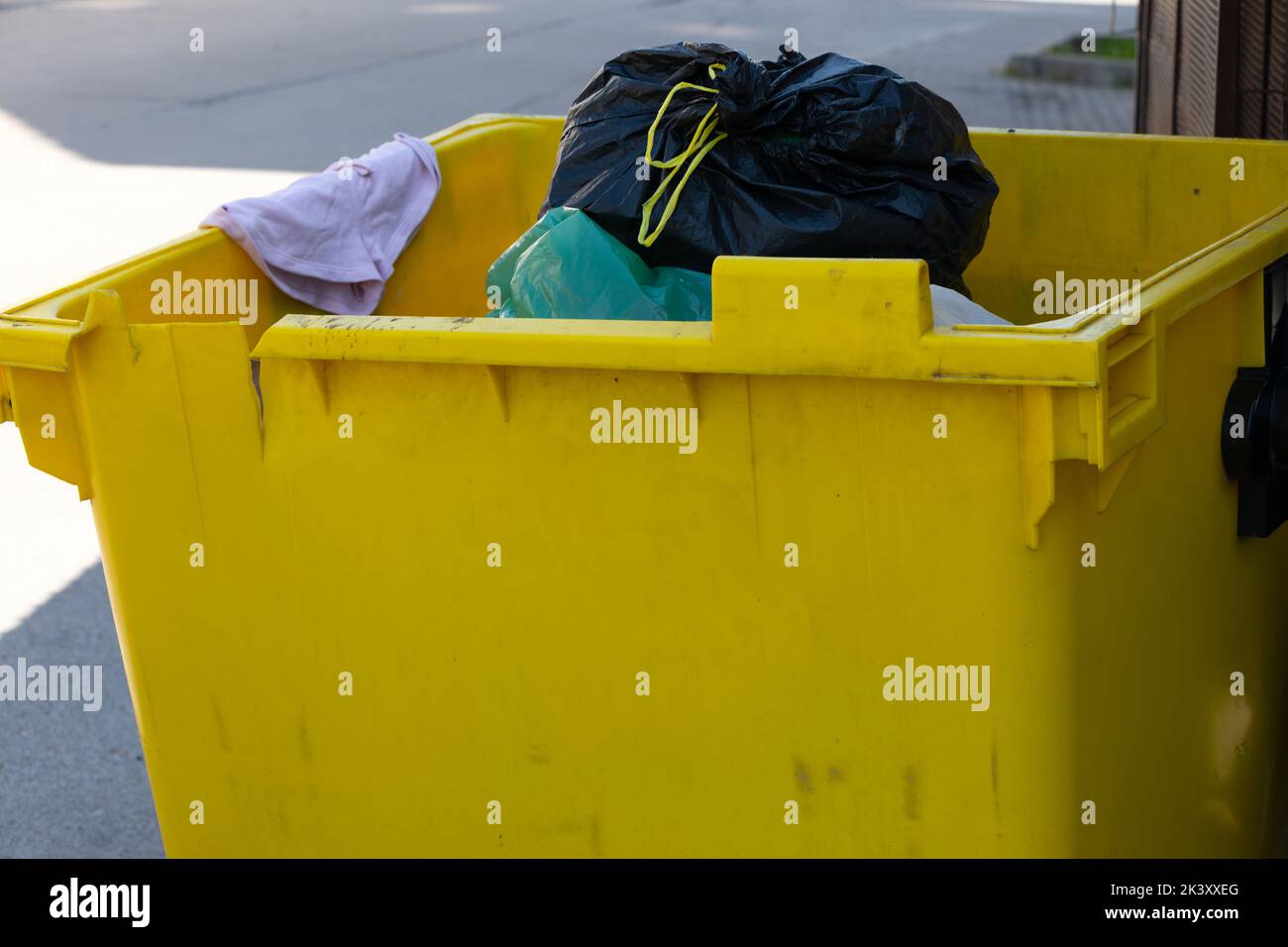 Close up picture of trash bin full of garbage on the street Stock Photo ...