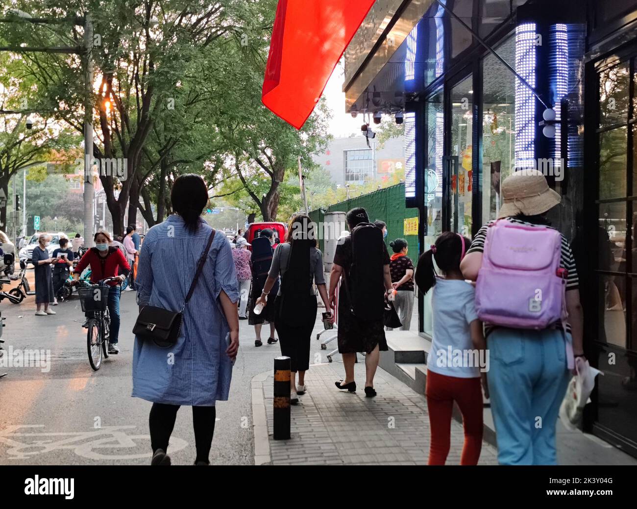 BEIJING, CHINA - SEPTEMBER 28, 2022 - Citizens walk through a street in ...