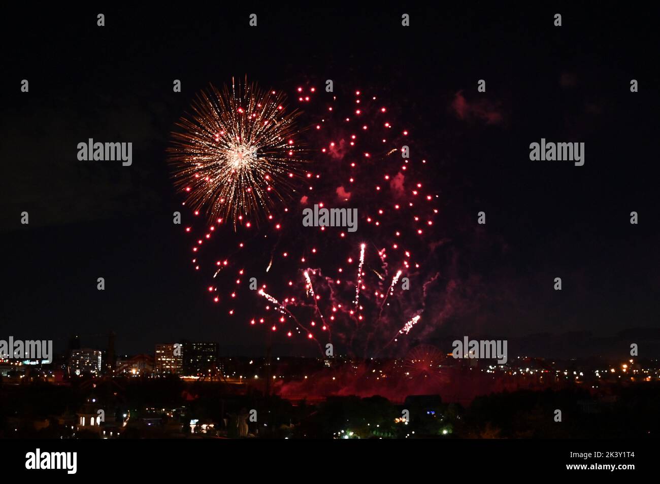 A beautiful view of red fireworks in the night sky Stock Photo - Alamy