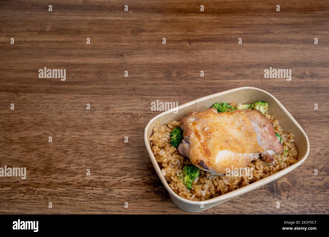 chicken and fried rice lunch box on the wooden table top Stock Photo ...