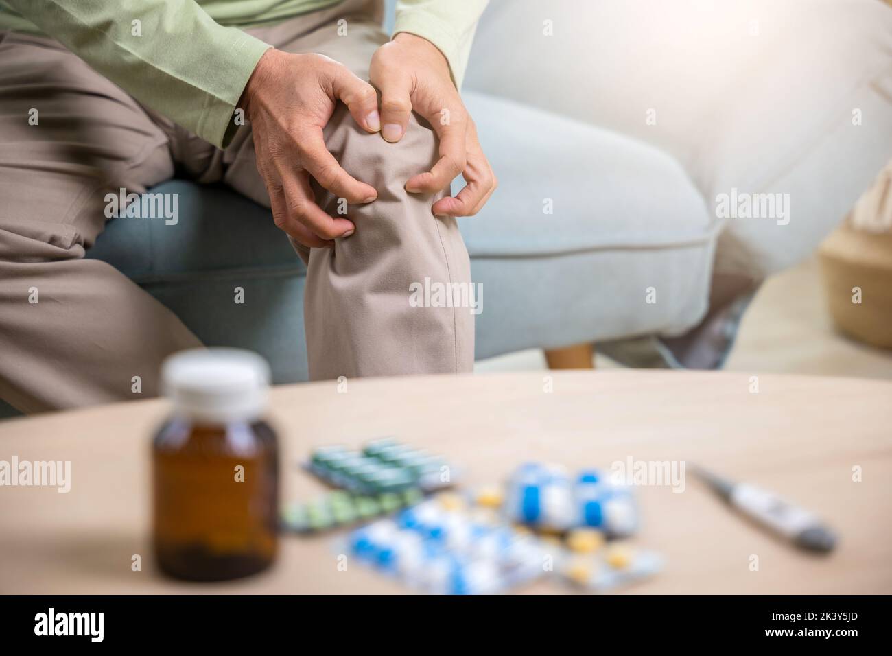 Old age. Asian senior man retirement knee joint pain on sofa, Elderly ...