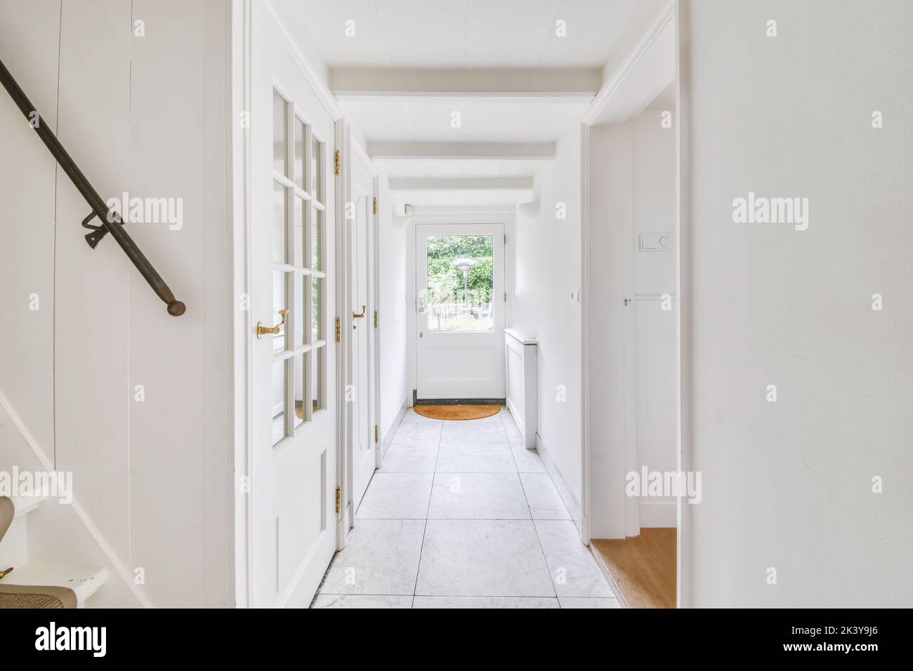 Light narrow hallway with many doors in white walls and glowing lamp ...