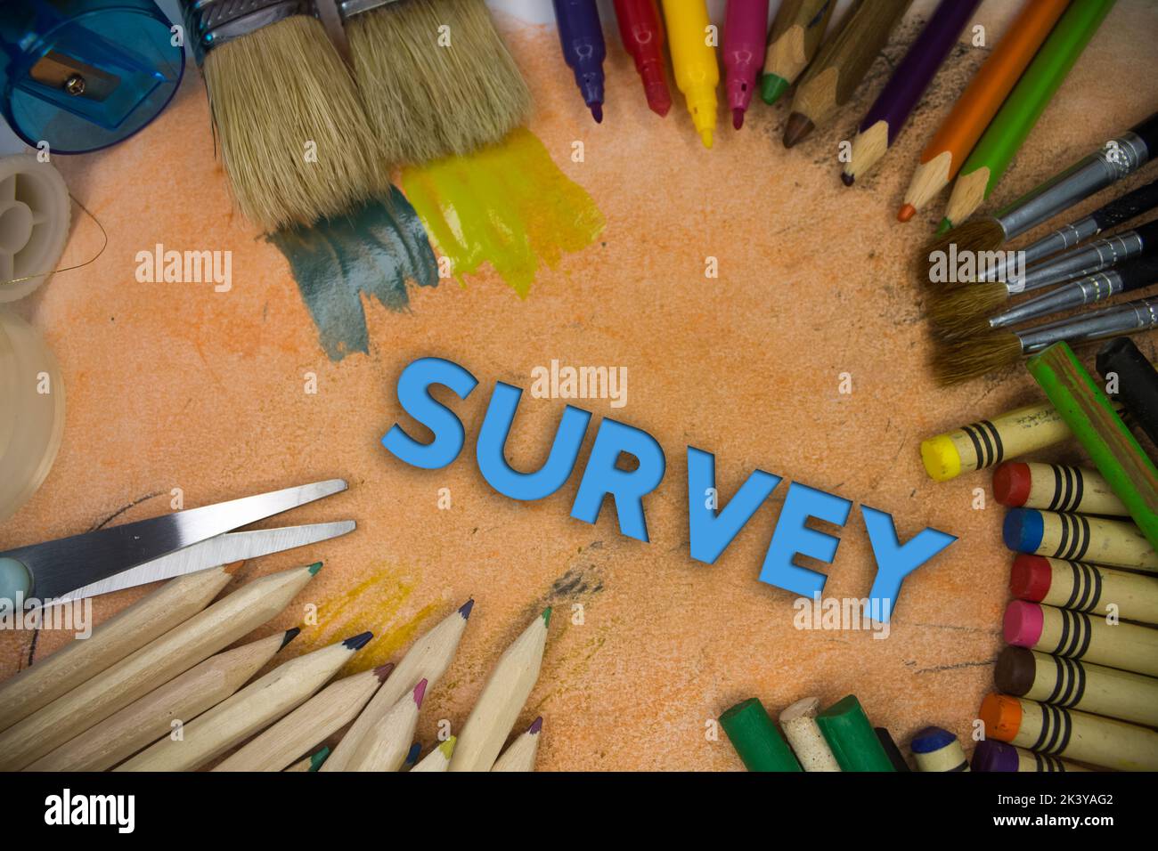 Overhead shot of school supplies with Survey text. Brushes, pencils ...