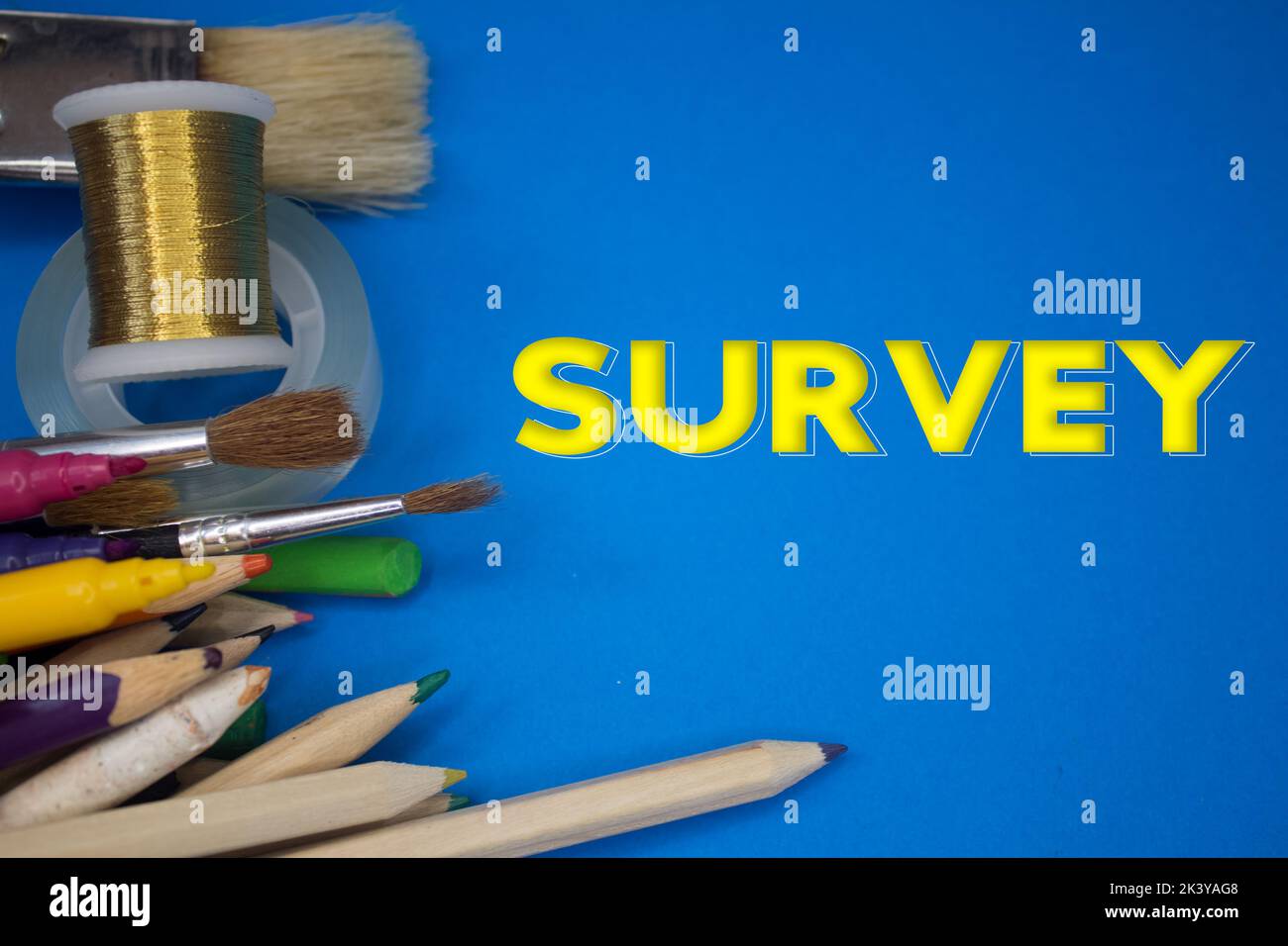 Overhead shot of school supplies with Survey text. Brushes, pencils ...