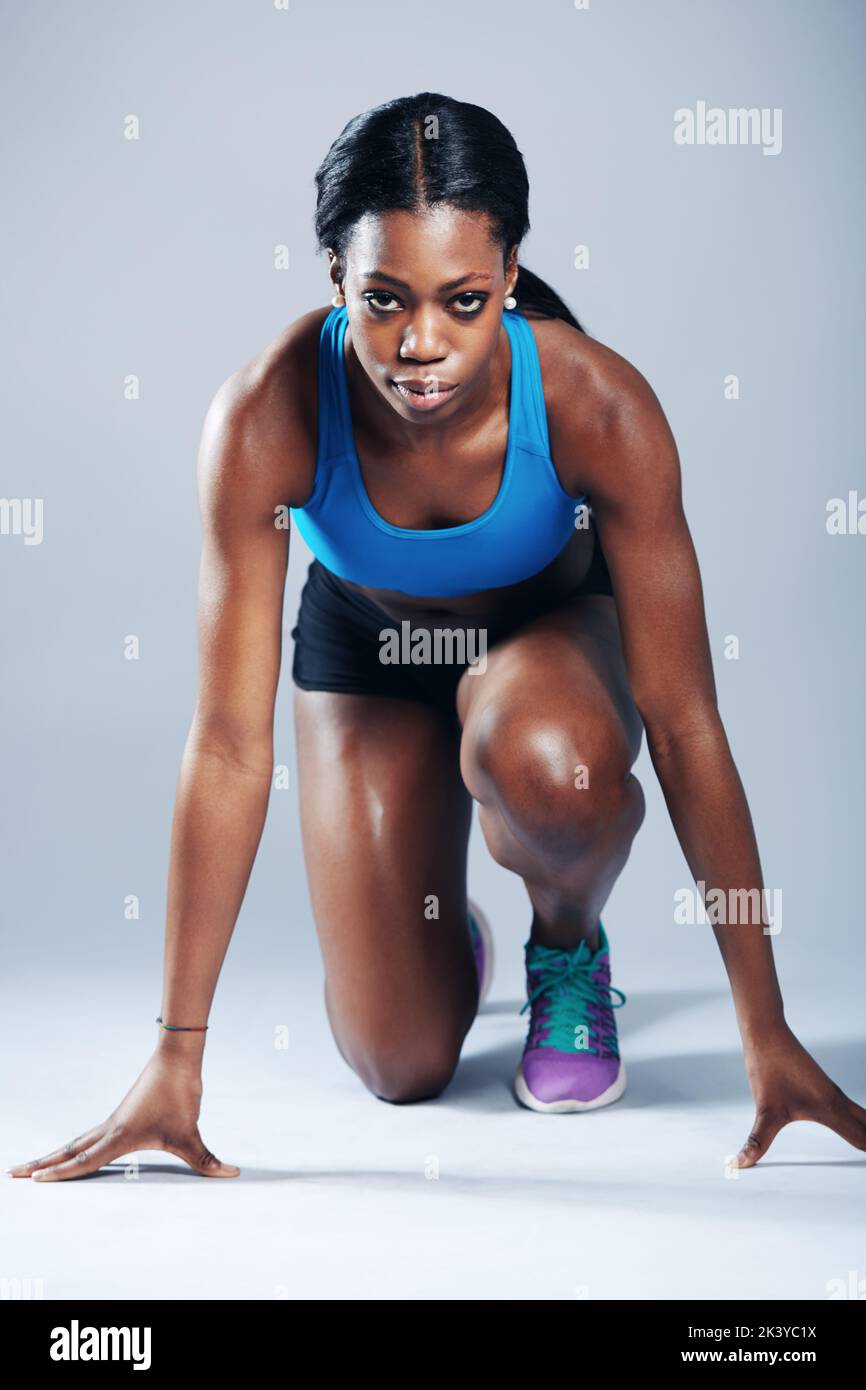 Ready, set.....A young African-American athlete poised in the starting ...