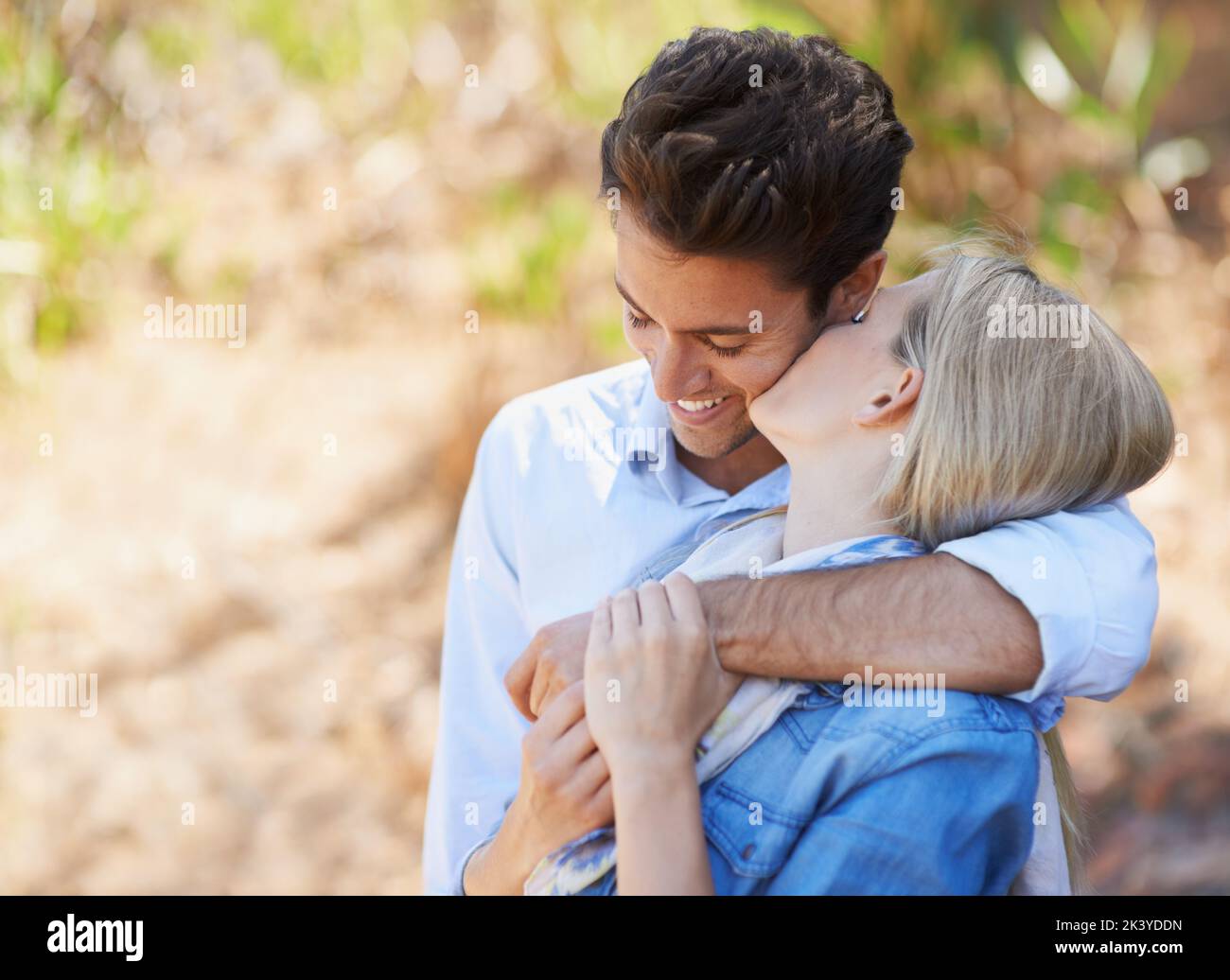 Let me tell you a secret... I love you. A loving young couple standing ...