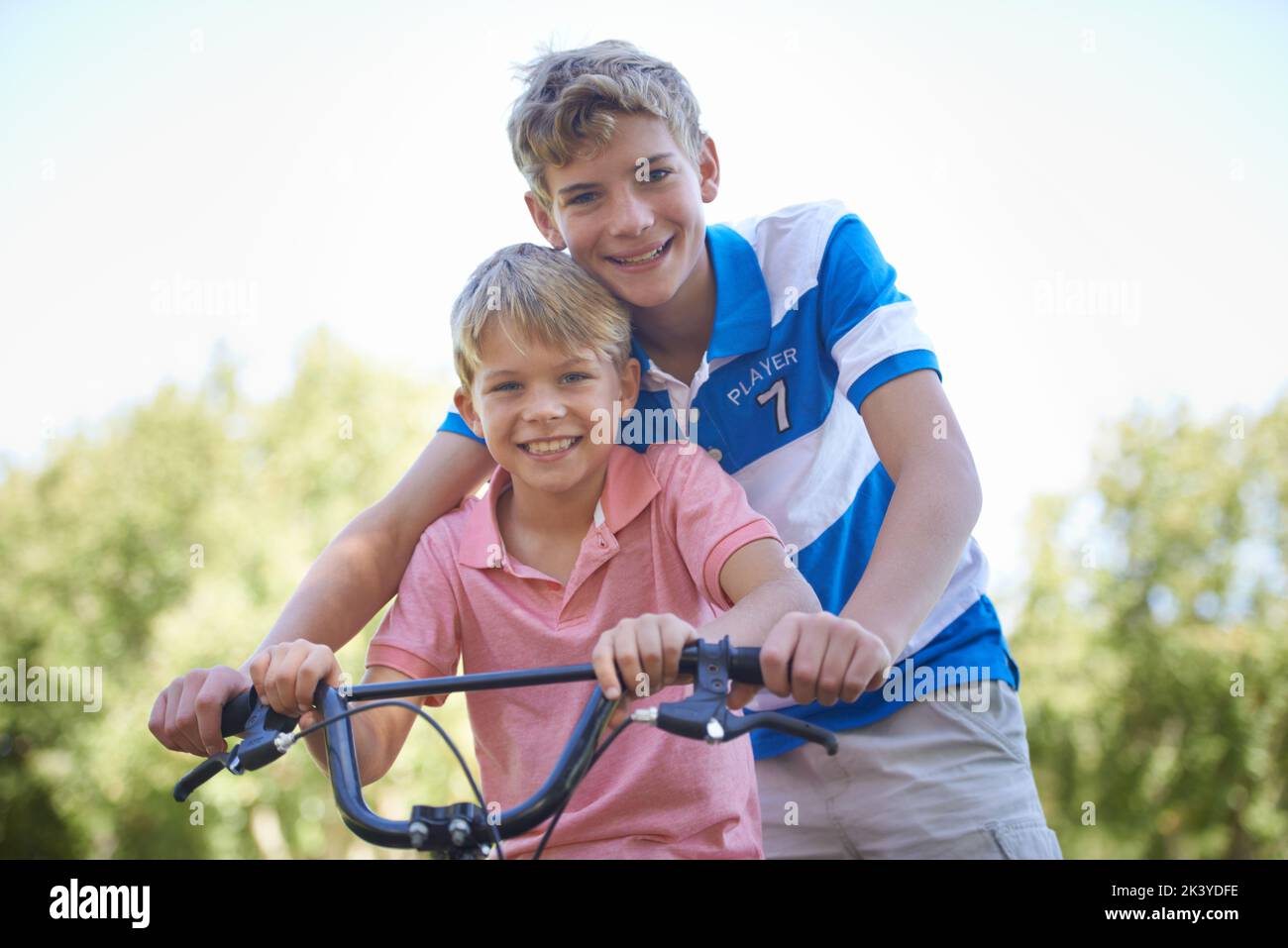 Teaching him all he knows about riding. Portrait of two brothers ...