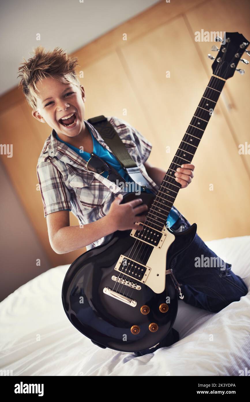 Boy playing electric guitar hi-res stock photography and images - Alamy