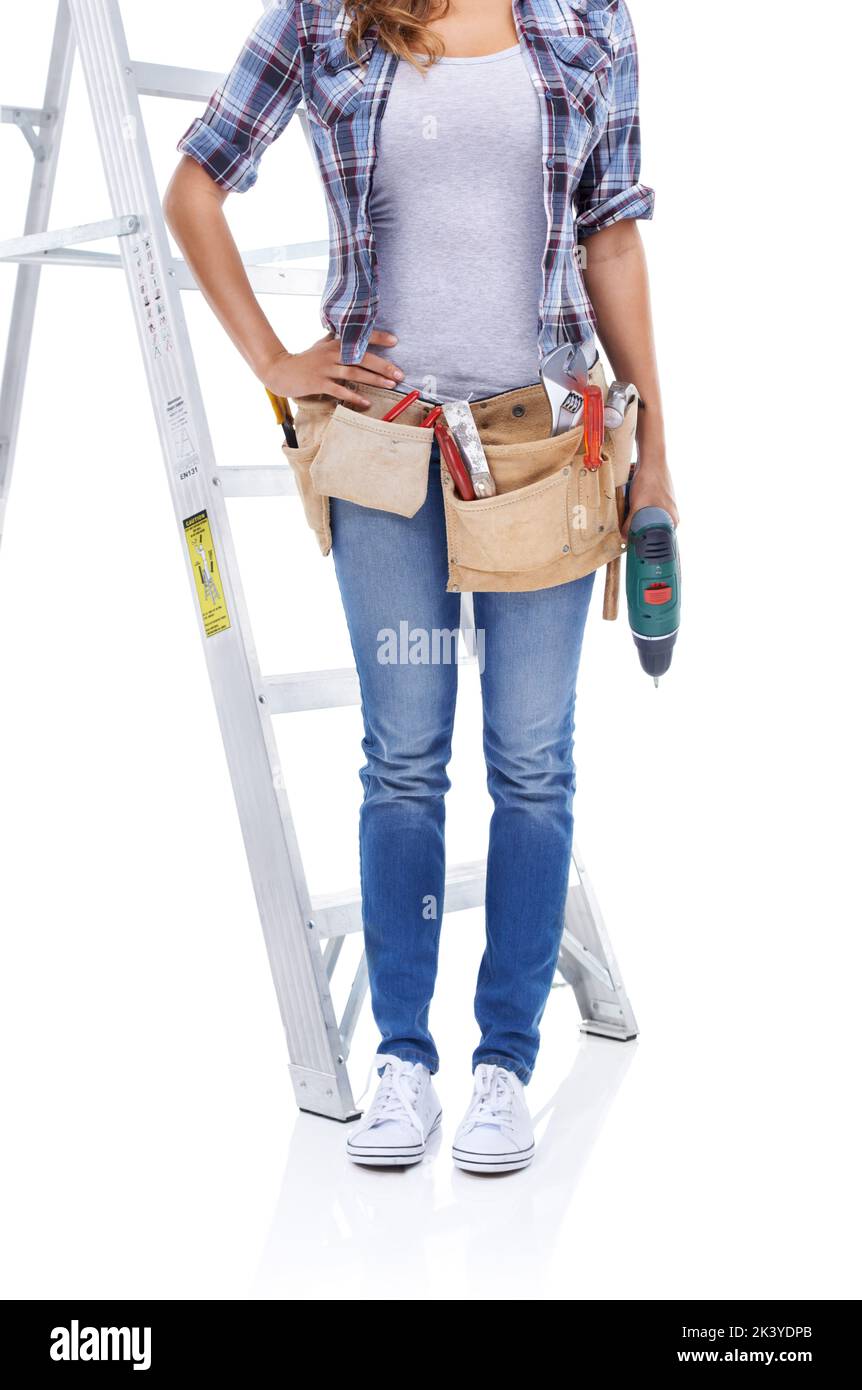 As good as any man on the job. a young woman standing next to a ladder ...