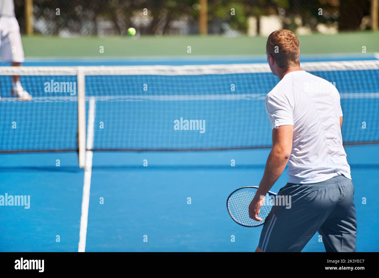 Showing up to every tennis practice. two people playing tennis outside ...