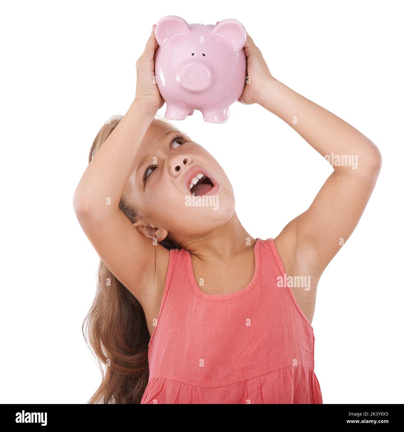 Keeping an eye on her savings. An adorable little girl looking for ...