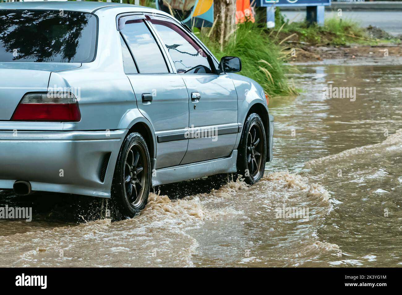 Car passing through a flooded road. Driving car on flooded road during ...