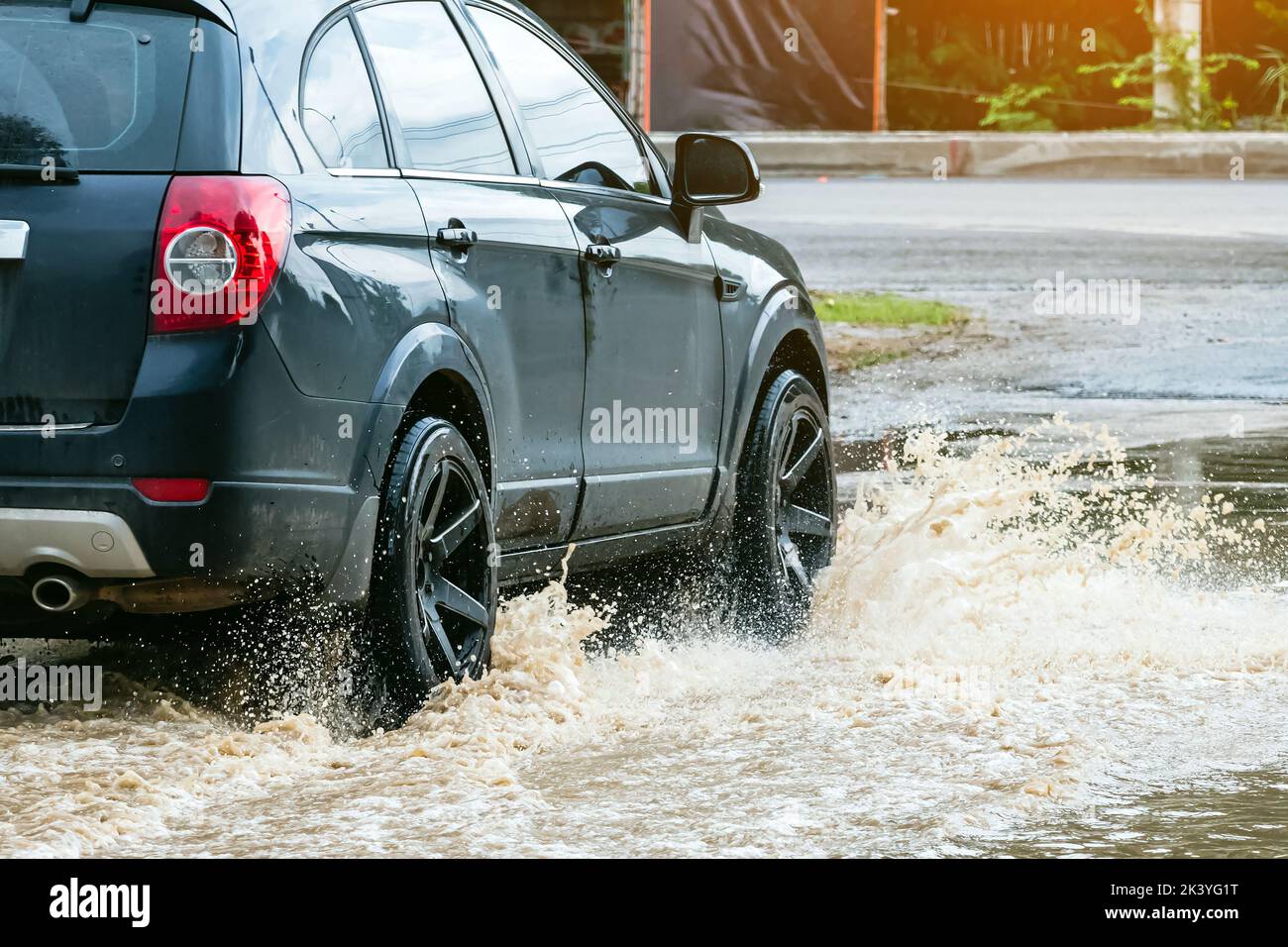 Car passing through a flooded road. Driving car on flooded road during ...