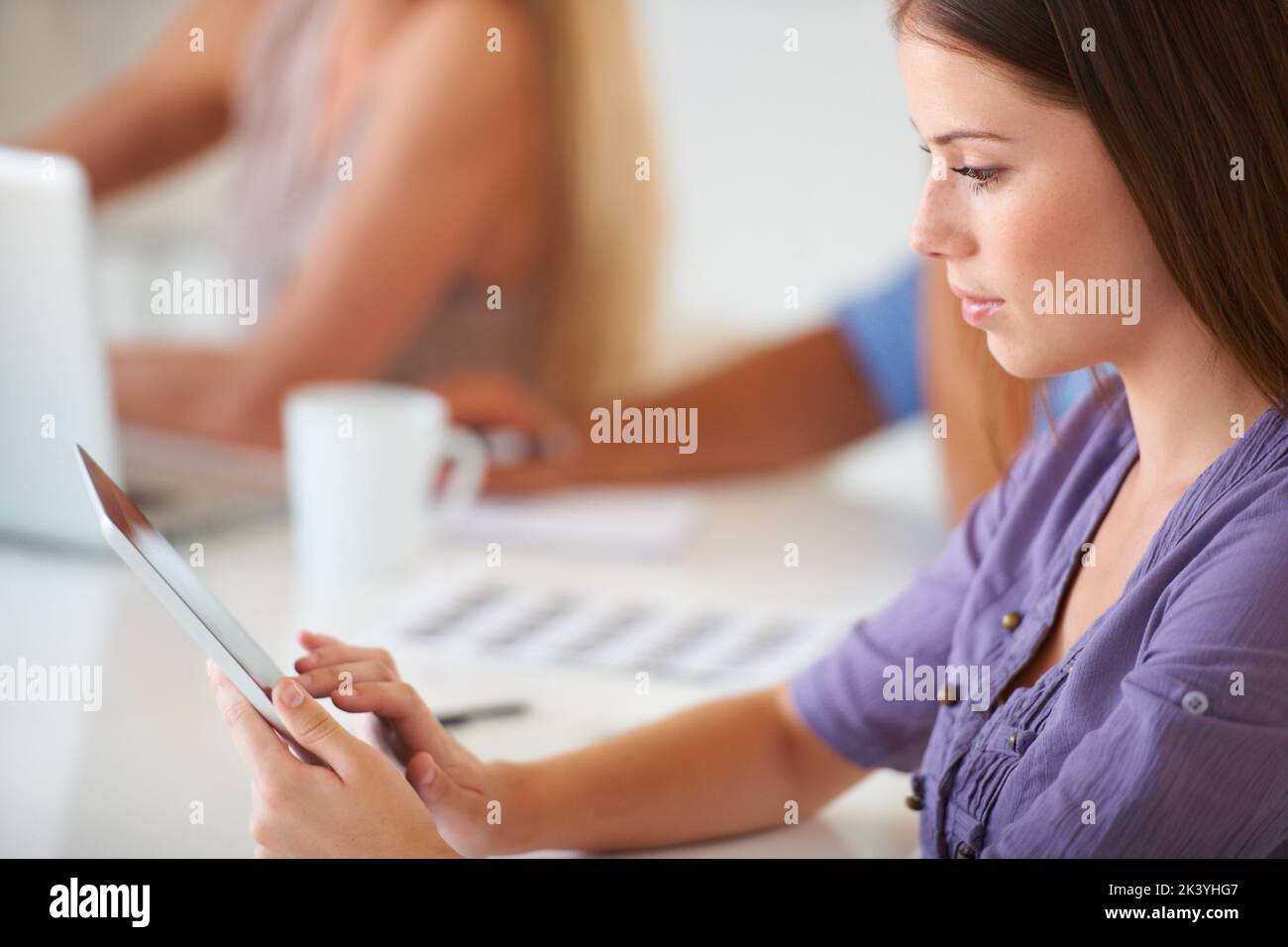 Typing an email. A gorgeous young creative businesswoman working on her ...