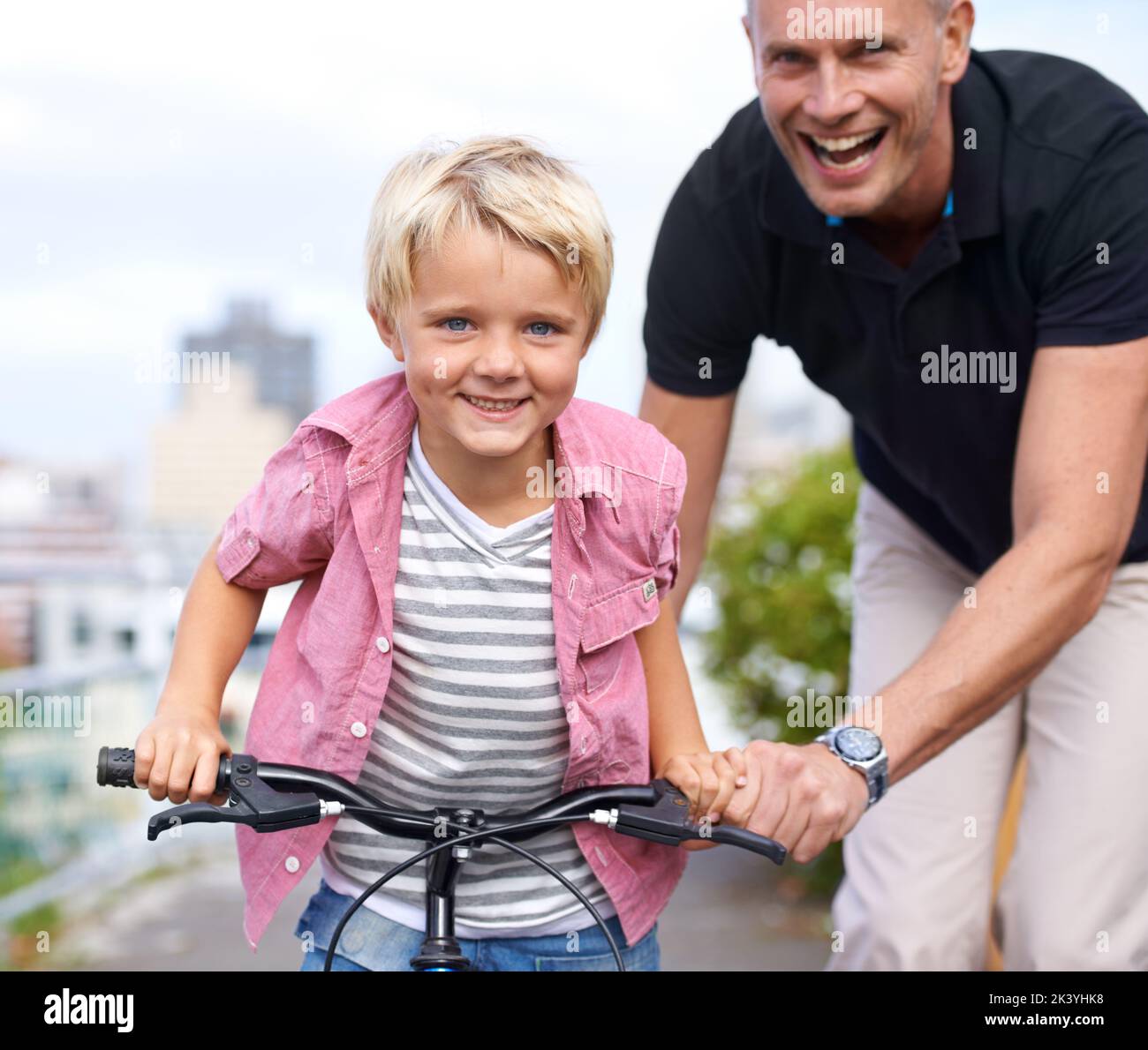 Special father and son moments. A happy father teaching his son how to ride a bike Stock Photo ...