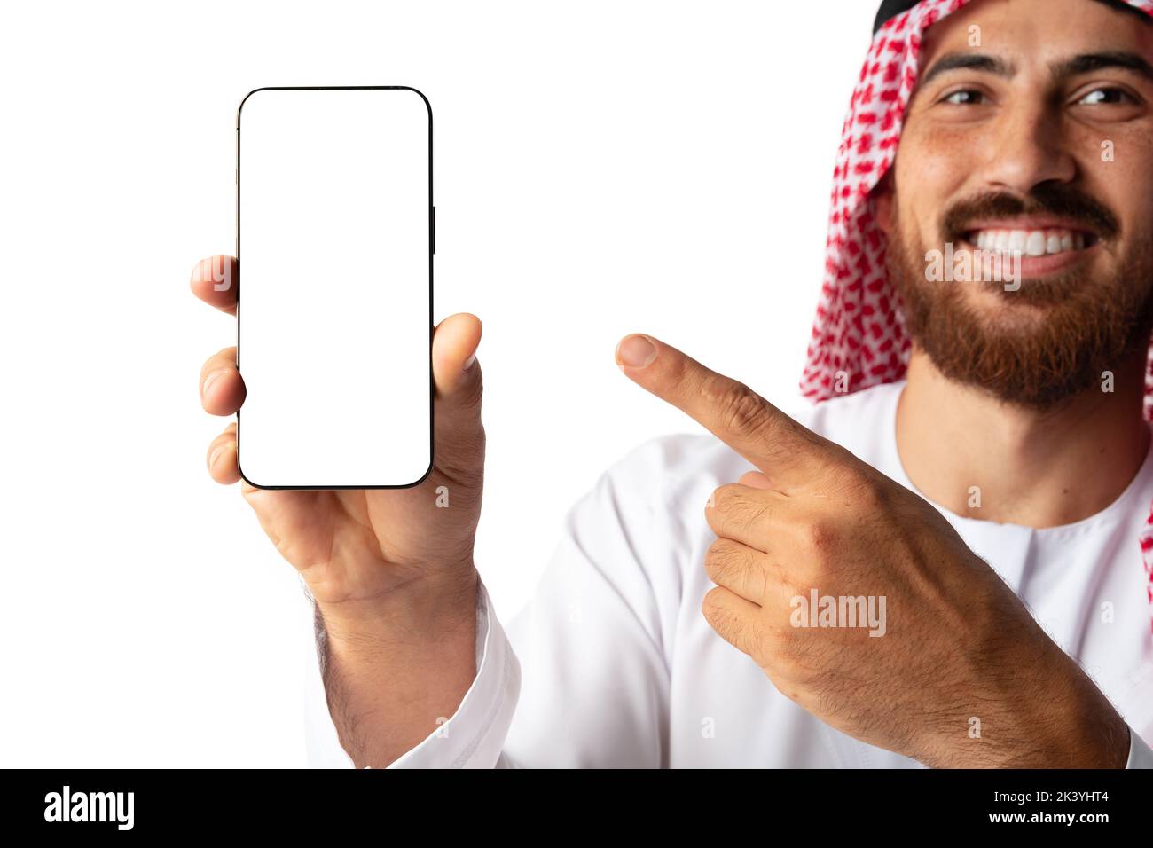 Young Arab muslim man in traditional clothes showing mobile phone ...