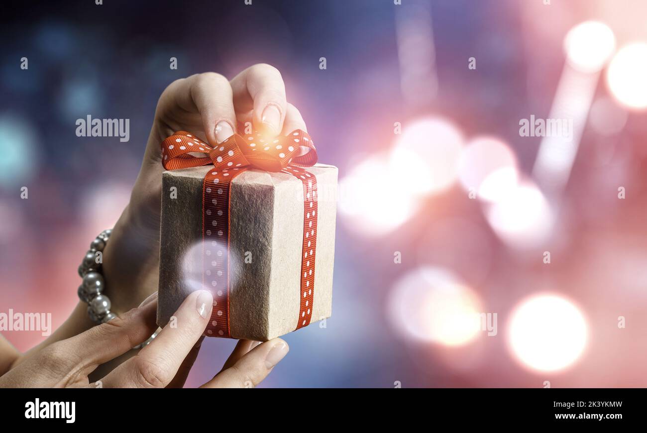 Closeup hands giving surprise gift box Stock Photo - Alamy