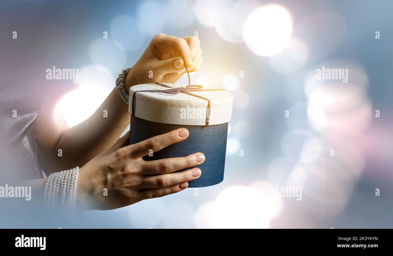 Closeup hands giving surprise gift box Stock Photo - Alamy
