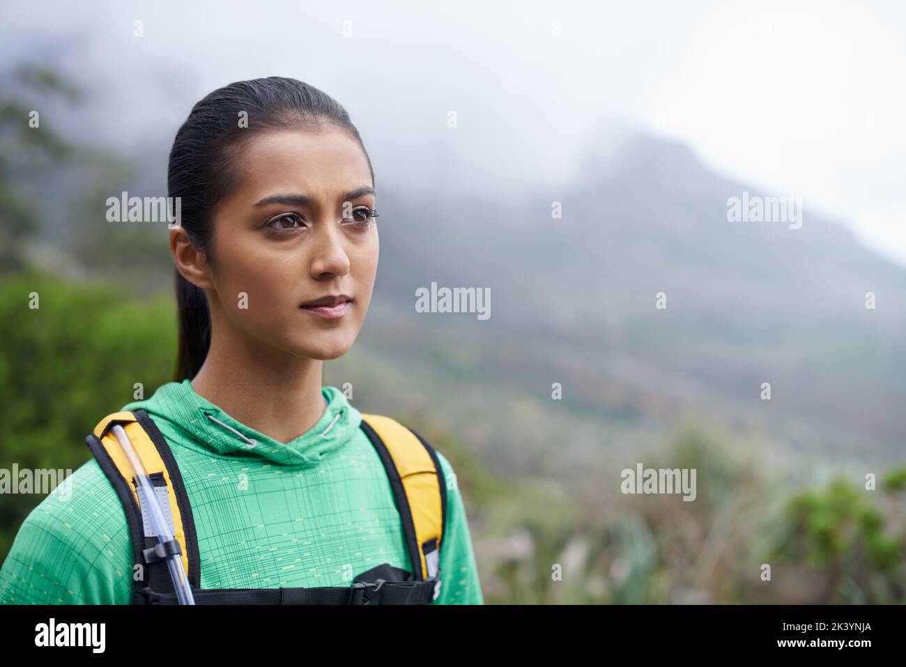 She loves trail running. A beautiful young woman standing against a ...