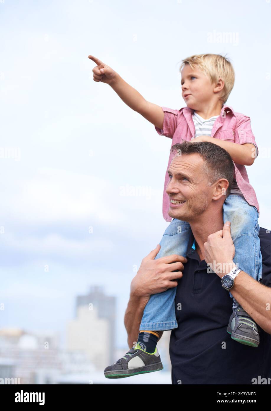 Look over there, Dad. A handsome father carrying his son on his ...