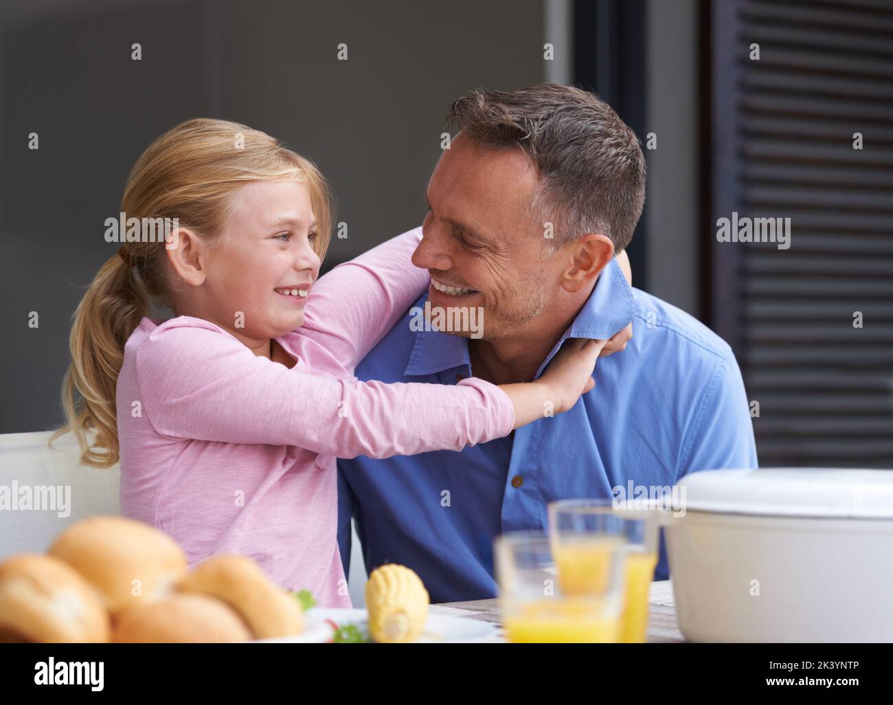 Thanks for lunch dad. A young girl hugging her father while out for ...