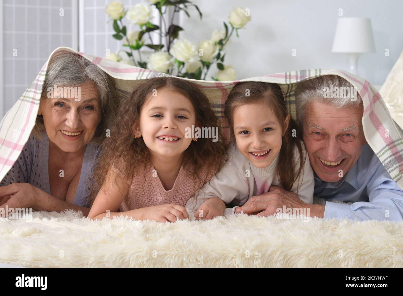 Grandparents and grandchildren lie on the bed Stock Photo - Alamy