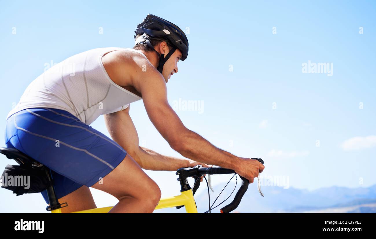 Enjoying the scenery while exercising. Cropped view of a cyclist ...